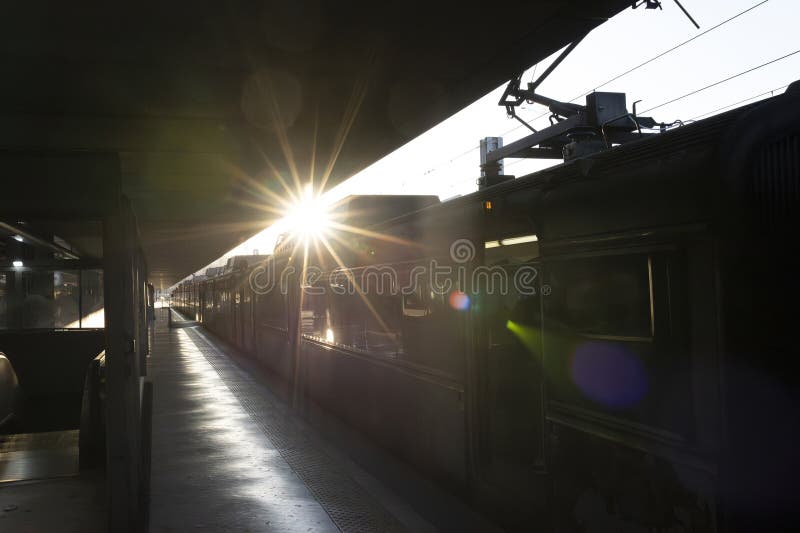 A Train is on the Tracks with the Sun Shining on it Stock Photo - Image ...