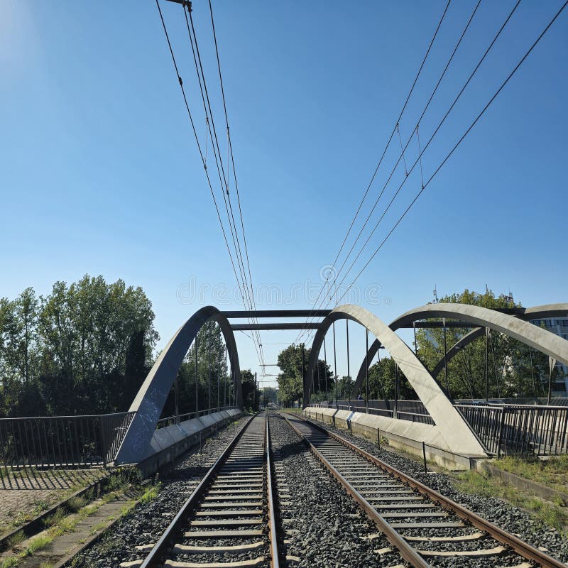 The Train Tracks Under a Modern Arch Bridge Evoke Awe, Showcasing ...