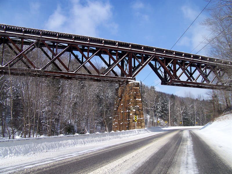 Train Trestle Bridge Over A Snowy Road Stock Photo - Image of road ...
