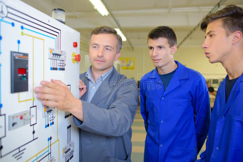 Trainee Electricians Looking at Wiring Plan Stock Image - Image of ...