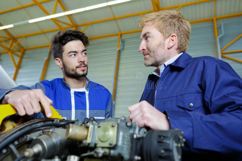 Trainee Engineer Studying Plans with CMM Arm in Foreground Stock Image ...