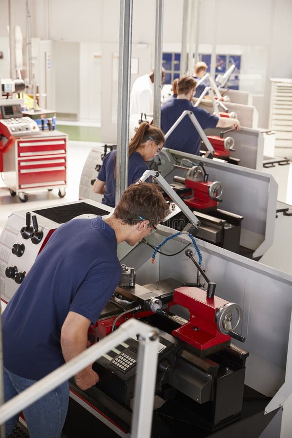 Two Engineers Operating CNC Machinery on Factory Floor Stock Photo ...