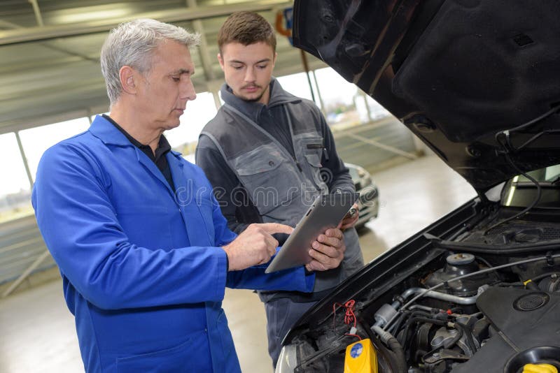 Trainee mechanic at work stock photo. Image of female - 266081924