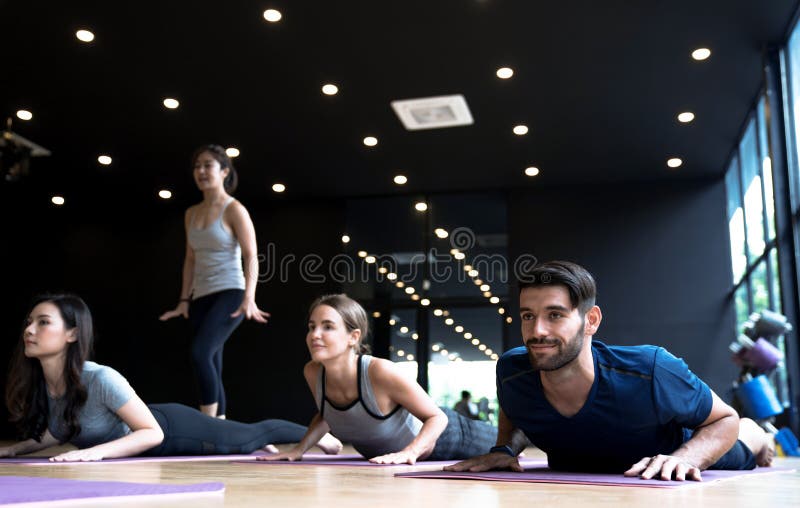 The Trainer Adjusts the Correct Posture for the Student To Learn Yoga ...