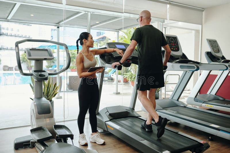 Trainer Assisting Client during Treadmill Workout Session Stock Image ...