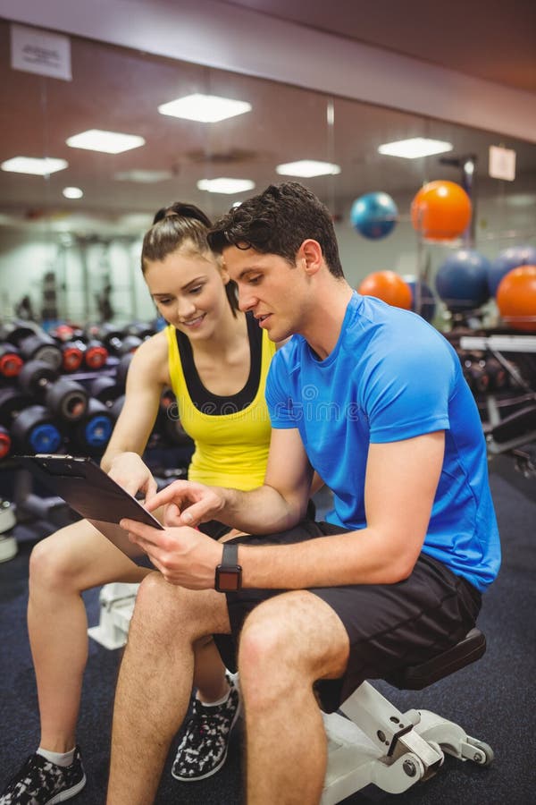 Trainer and Client Discussing Her Progress Stock Photo - Image of ...