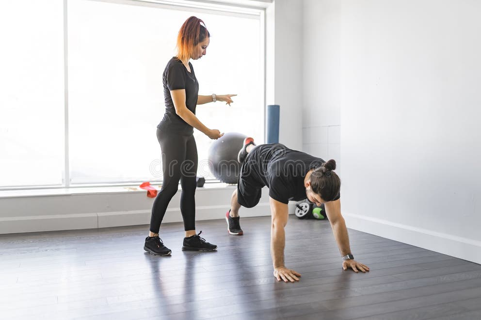Trainer and Client Discussing Her Progress at the Gym Stock Image ...