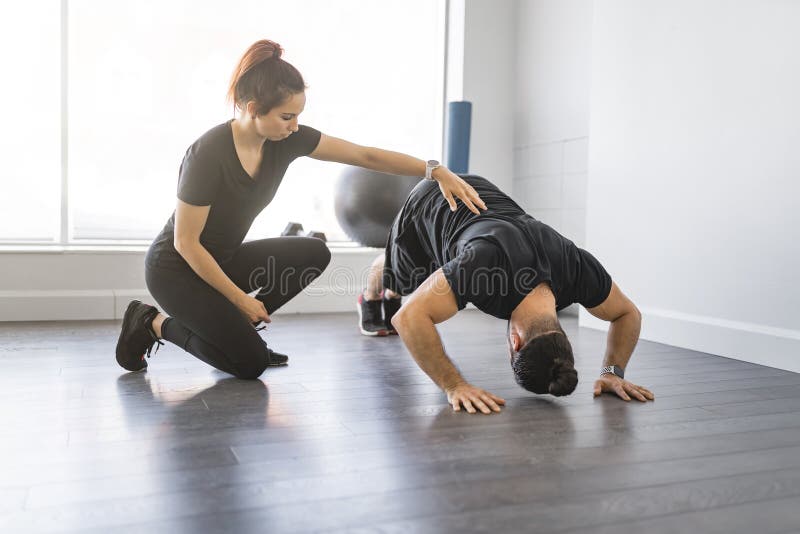 Trainer and Client Discussing Her Progress at the Gym Stock Photo ...