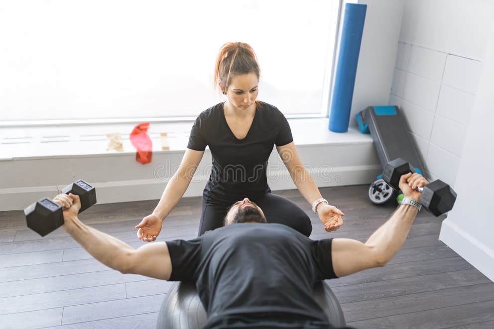 Trainer and Client Discussing Her Progress at the Gym Stock Image ...