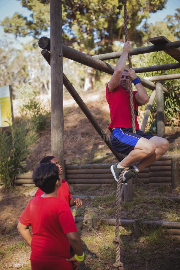 Trainer Climbing a Rope during Obstacle Course Training Stock Image ...