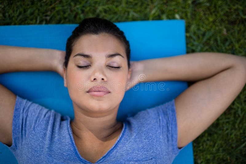 Trainer with Closed Eyes Resting on Exercise Mat Stock Photo - Image of ...