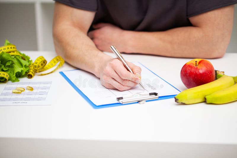 Trainer Draws Up a Training Program and a Healthy Diet Plan Stock Photo ...