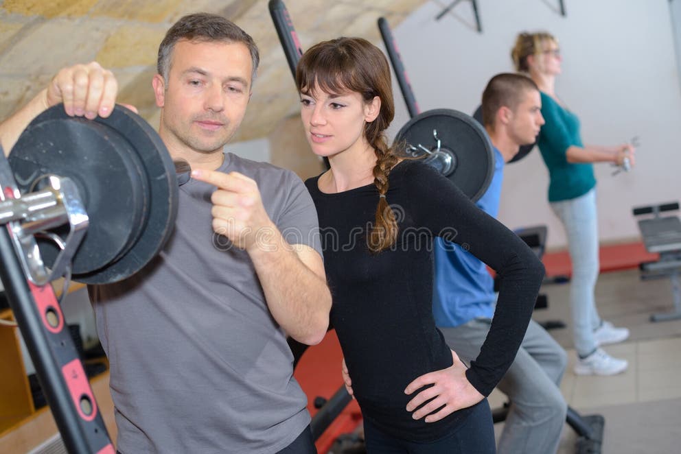 Trainer Explaining How To Use Training Machine in Gym Stock Image ...