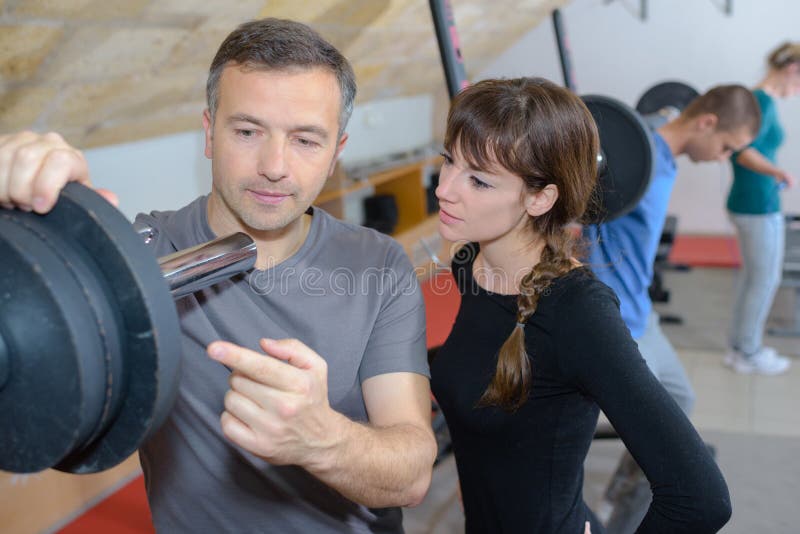 Trainer Explaining How To Use Training Machine in Gym Stock Photo ...