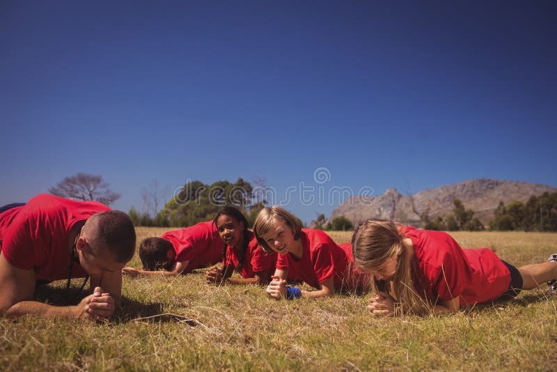 Trainer Instructing Kids while Exercising in the Boot Camp Stock Photo ...