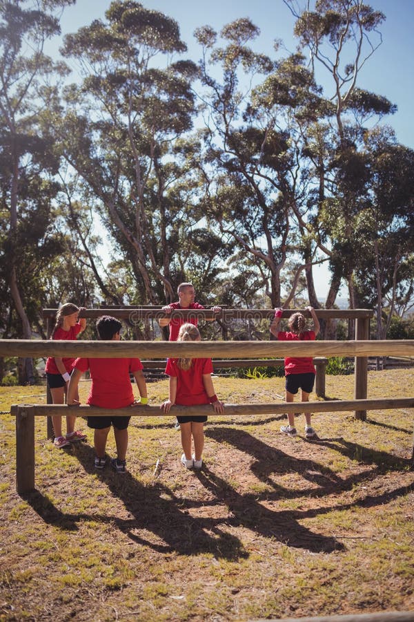 Trainer Instructing Kids during Obstacle Course Training Stock Photo ...