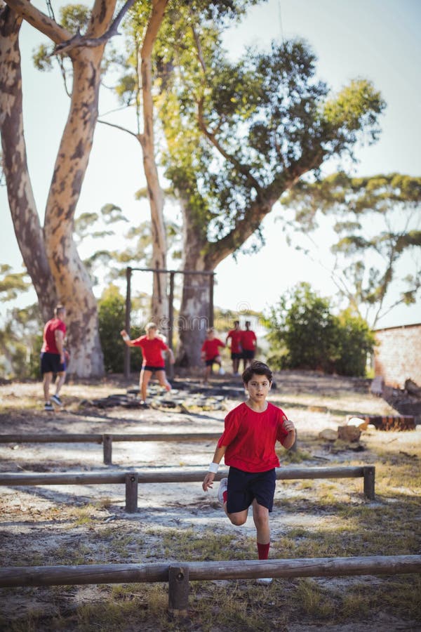 Kids Crawling Under the Net during Obstacle Course Training Stock Photo ...
