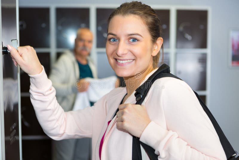 Trainer opening her locker stock photo. Image of school - 117485122