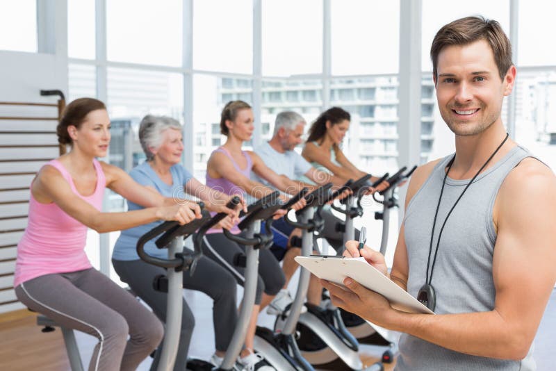 Trainer with People Working Out at Spinning Class Stock Photo - Image ...