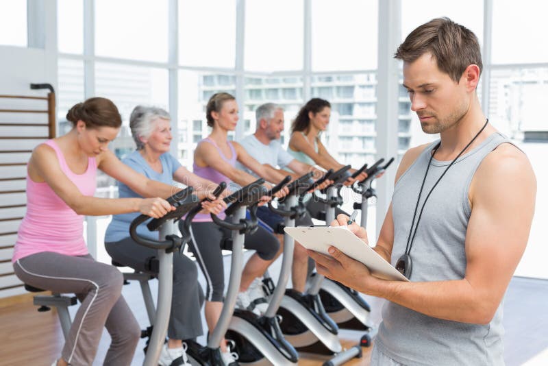 Trainer with People Working Out at Spinning Class Stock Image - Image ...
