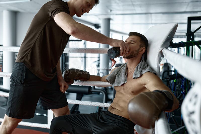 Trainer Refreshing Young Boxer in Ring Corner Stock Image - Image of ...