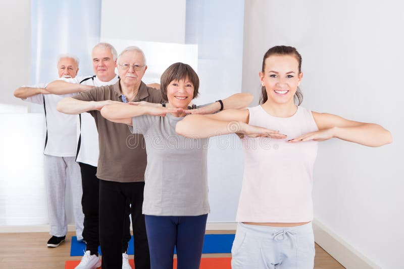 Trainer and Senior Customers Exercising Stock Photo - Image of smiling ...
