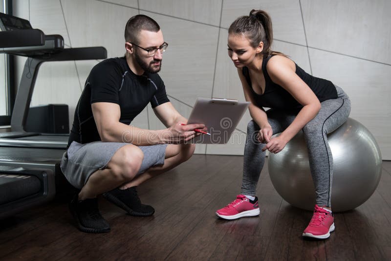 Trainer Takes Notes while Woman Sitting and Resting Stock Image - Image ...