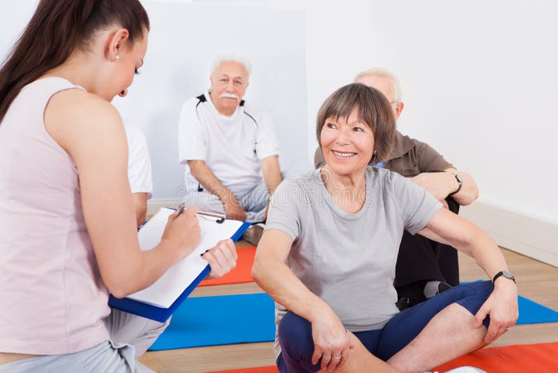Trainer Taking Notes from Senior Customers Stock Image - Image of ...