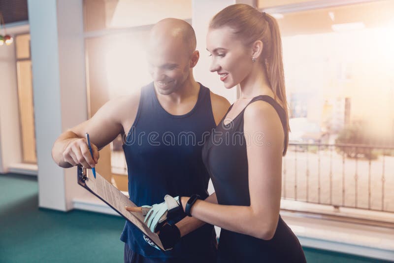 Trainer Writes a Fitness Program Training the Girl Stock Image - Image ...