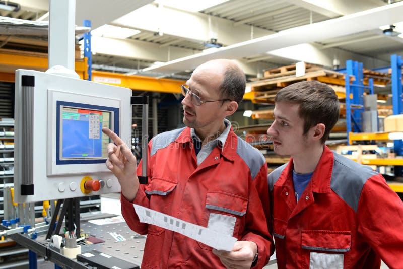 Engineer and Apprentice Using Automated Milling Machine Stock Photo ...