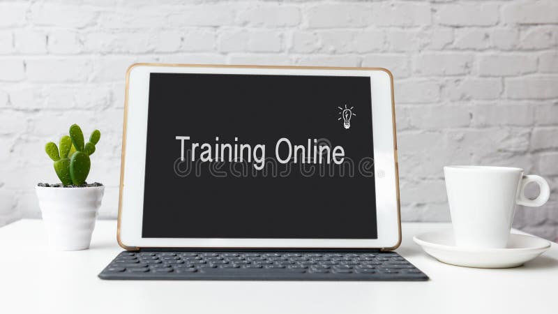 Training Courses Online Text on Laptop Screen on Table with Coffee Cup ...