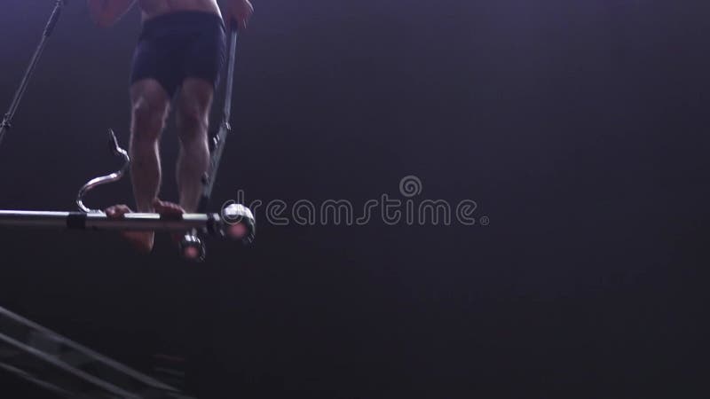 An Acrobatic Man Rotating Upside Down on the Flying Bar at Circus Stock ...