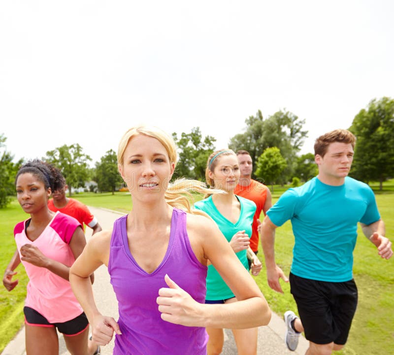 Training in the Fresh Air. Front View of a Group of Athletes Running ...