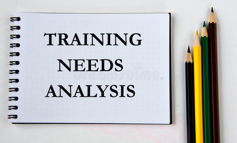 TRAINING NEEDS ANALYSIS - Words in White Notebook on White Background ...