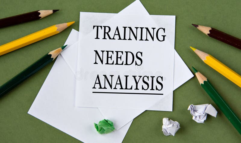 TRAINING NEEDS ANALYSIS - Words on White Paper on a Green Background ...
