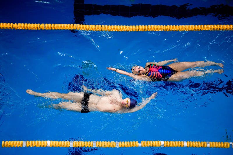 Training of Professional Swimmers. Athletes Swim on Their Backs in the ...