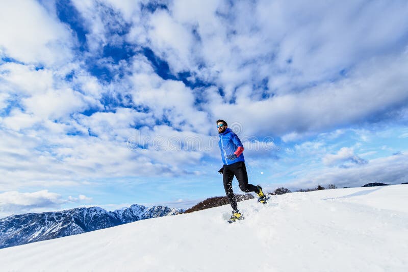 Training in the Snow with Downhill Running Snowshoes Stock Image ...