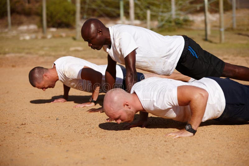 Training To Be Lean, Mean Fighting Machines. a Group of Men Doing Push ...