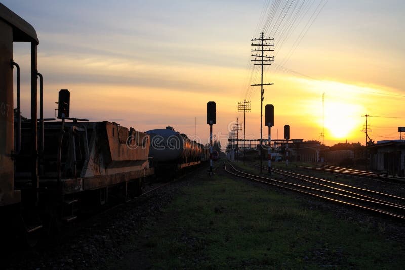 Trains on Railway Tracks by Train Station at Sunset Stock Photo - Image ...
