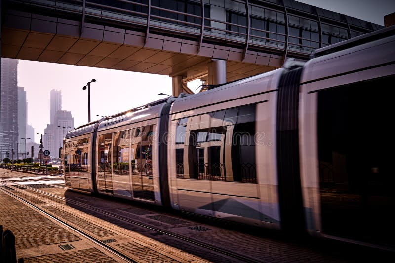 The Tram Rides Along the Rails in Dubai in the Summer in Dubai Marina ...
