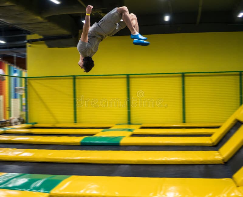 Trampoline Jumper Performs Acrobatic Exercises on the Trampoline Stock ...