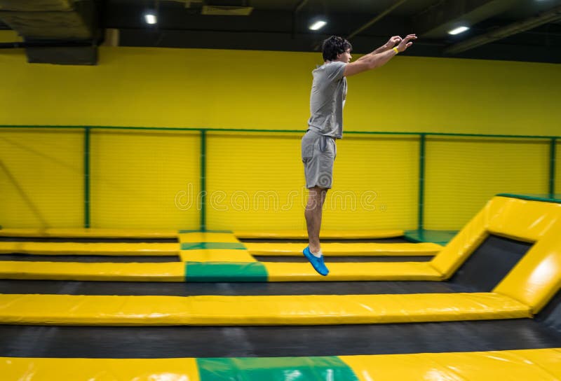 Trampoline Jumper Performs Acrobatic Exercises on the Trampoline Stock ...