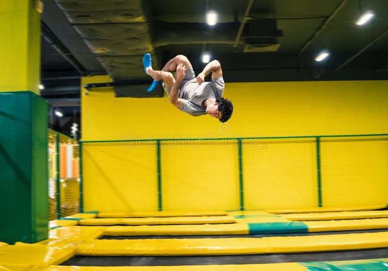 Trampoline Jumper Performs Acrobatic Exercises on the Trampoline Stock ...