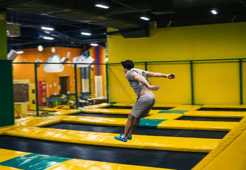 Trampoline Jumper Performs Acrobatic Exercises on the Trampoline Stock ...