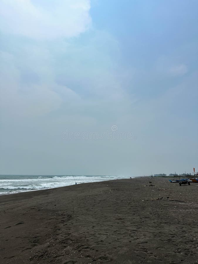Tranquil Beach Landscape Under Light Clouds and Gentle Waves by the ...