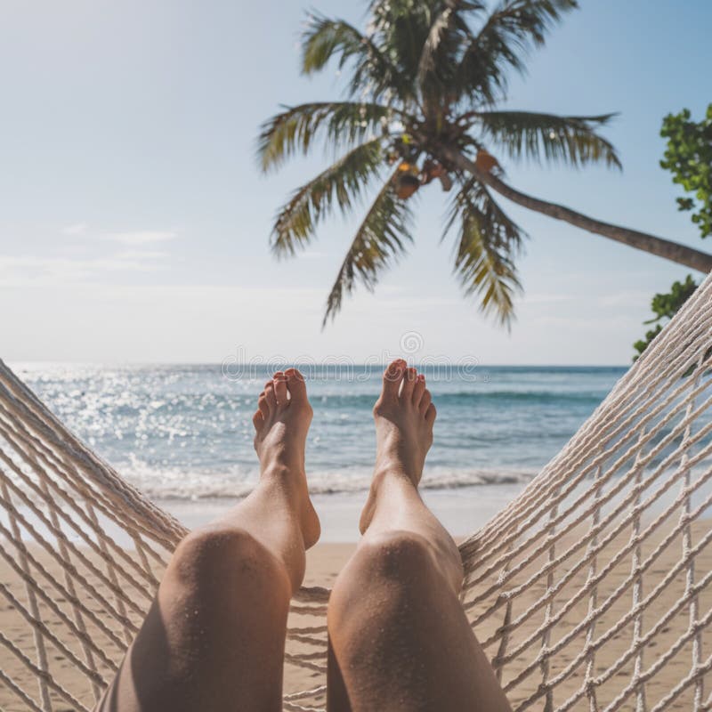 Tranquil Beach Scene Features Dangling Legs with a Palm Tree and ...