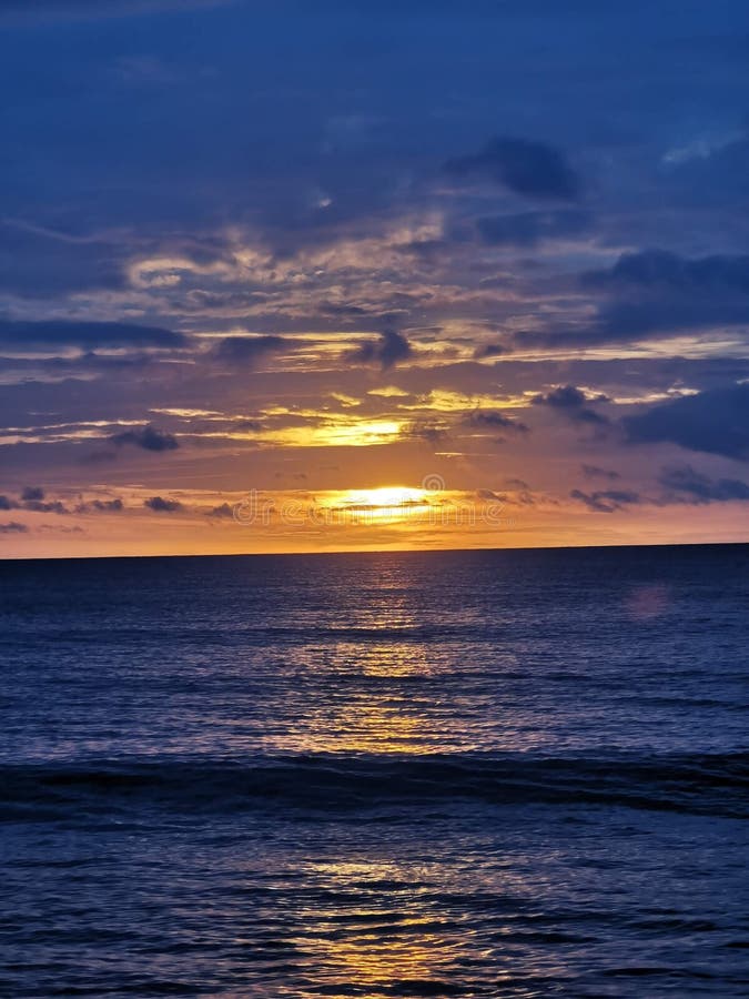 Tranquil Beach Scene with a Stunning Sunset Over the Horizon Stock ...