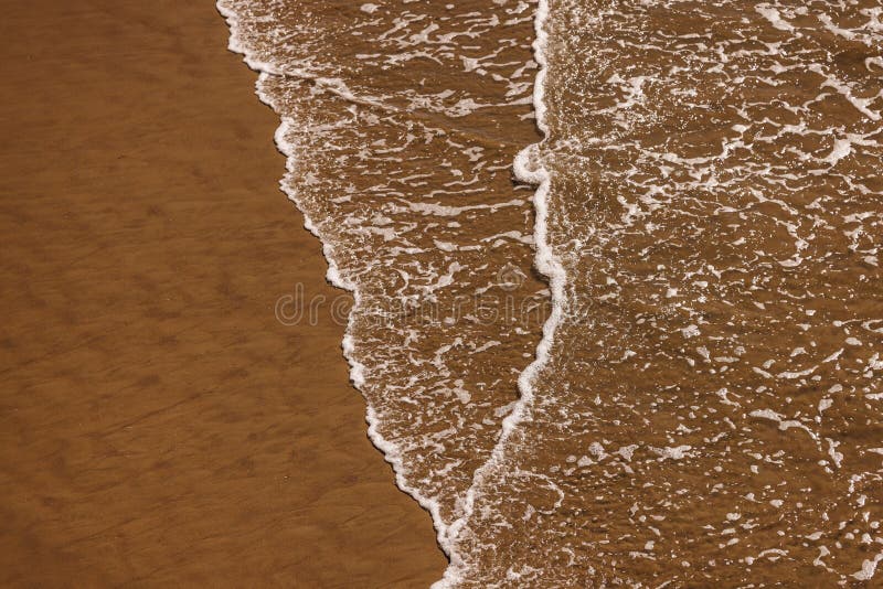 Tranquil Beachside Setting with a Brown Sandy Beach and Gentle Ocean ...