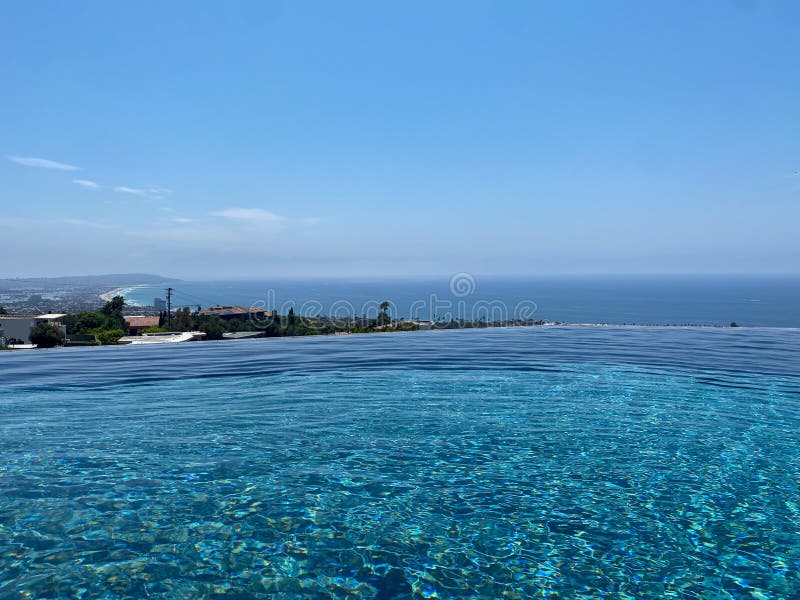 Tranquil Blue Infinity Pool Overlooking Ocean Stock Image - Image of ...