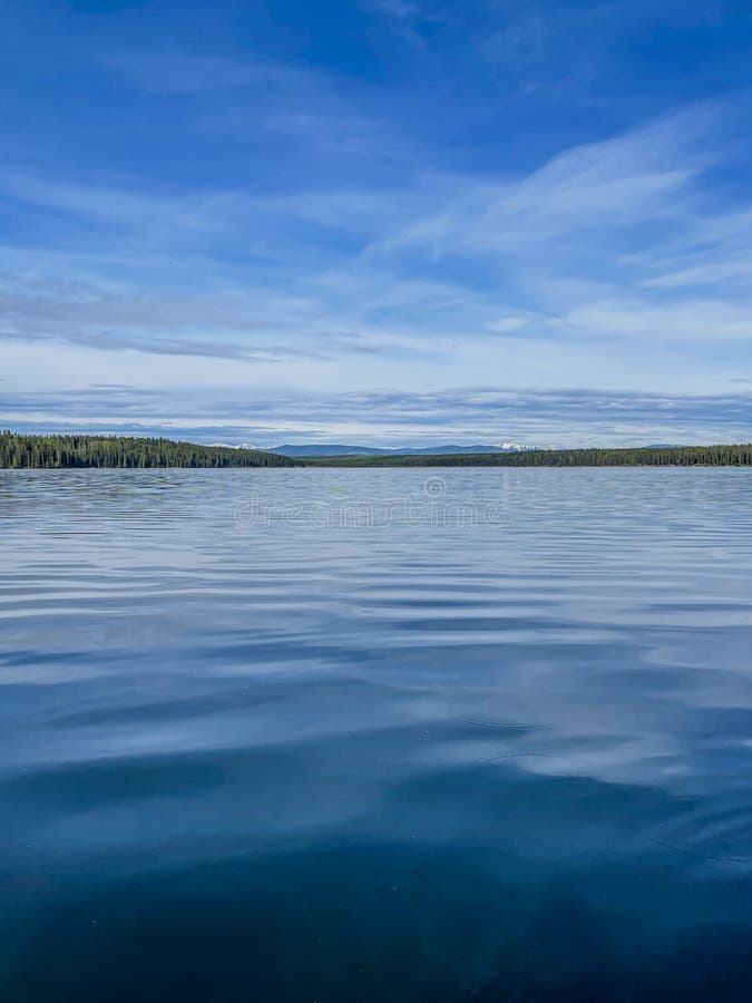 Calm Blue Lake with Gentle Ripples Under Clear Sky Stock Image - Image ...